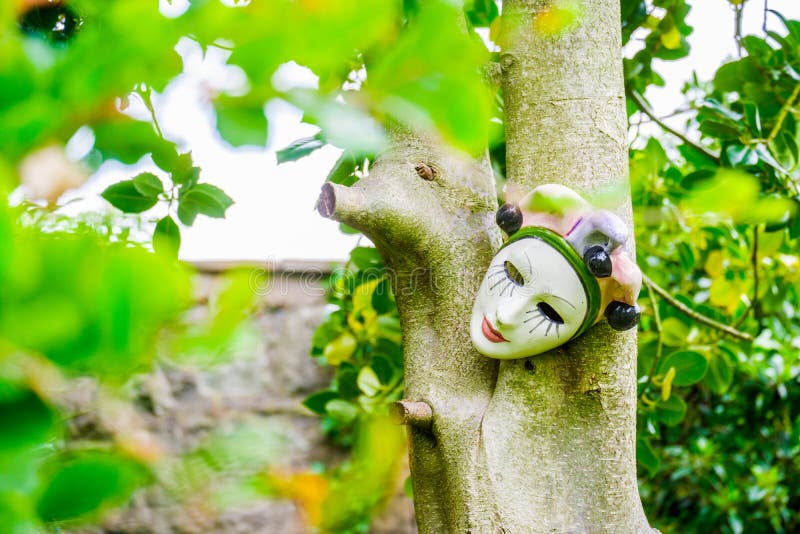 Human Face Baked Clay Mask on a Tree in a Garden Stock Image - Image of ...
