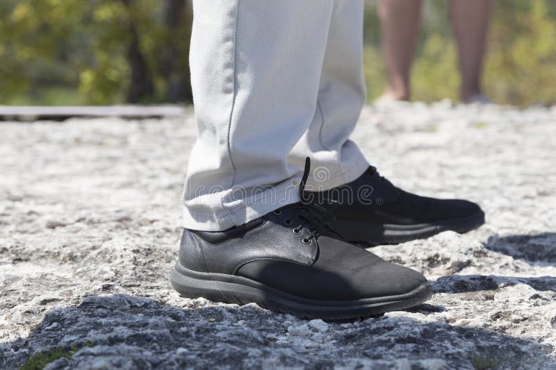 Human Feet in Shoes on a Stone Surface Stock Image - Image of black ...