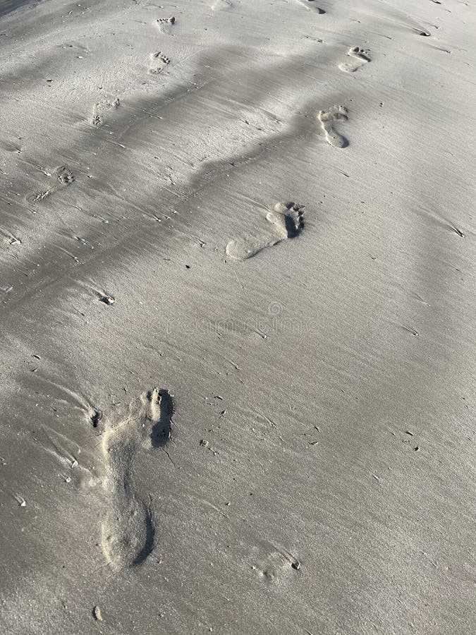 Human footprints in sand stock photo. Image of surface - 265379140