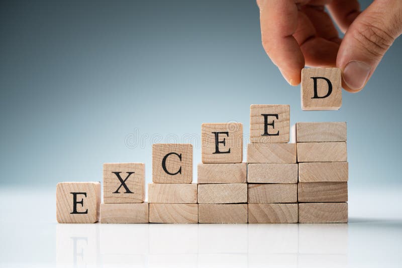 Human Hand Arranging Exceed Text Over Wooden Blocks Stock Photo - Image ...