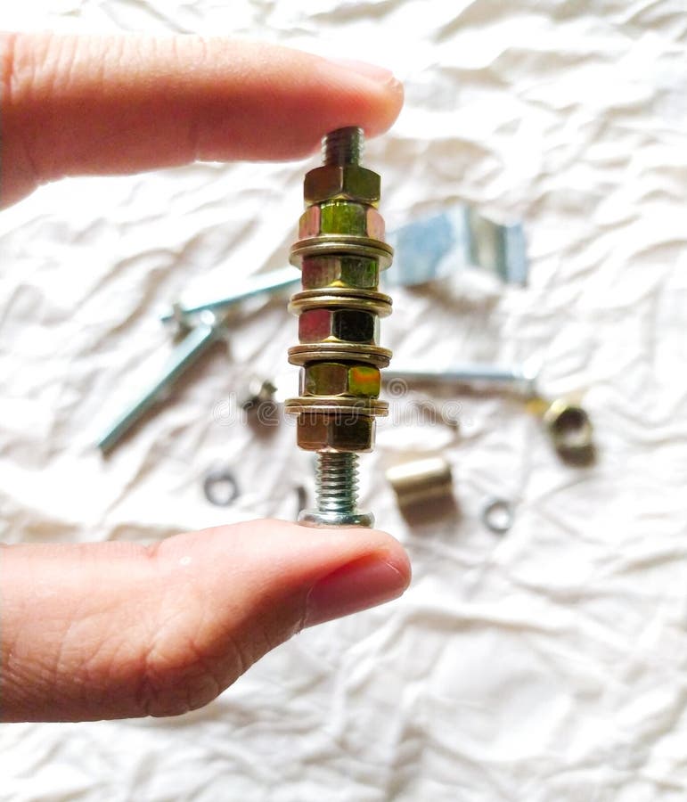 Hand Holding Stack of Nuts and Washers on Bolt for DIY Concept Stock ...