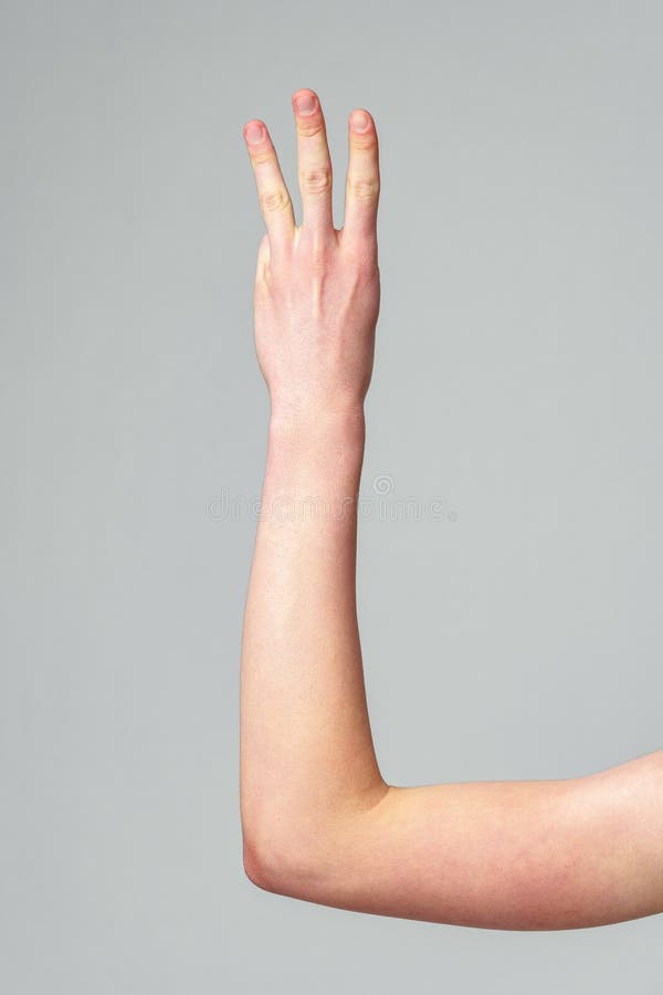 Human Hand Raised in a Gesture Against a Plain Grey Background Stock ...
