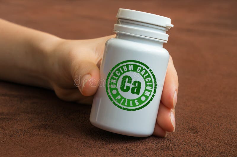Human Hand Holding a Bottle of Pills with Calcium Stock Image - Image ...
