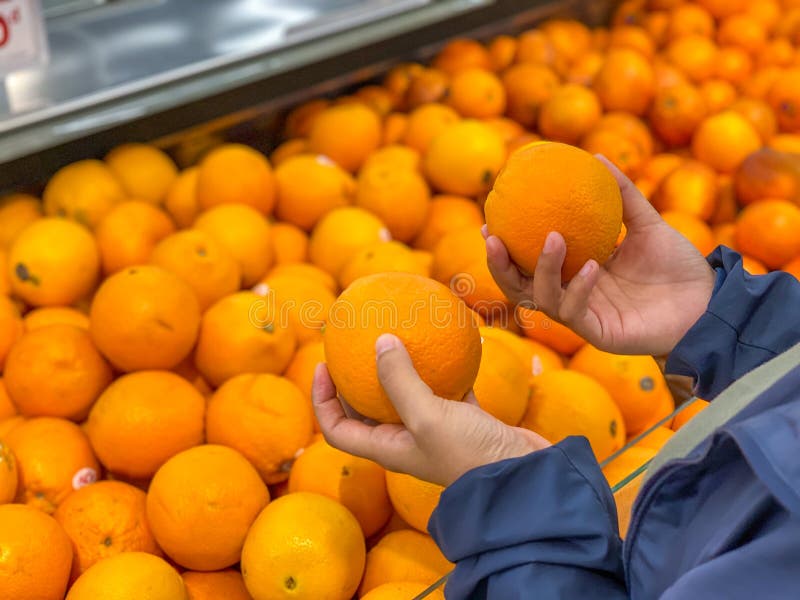 Human Hand Holding and Choosing Fresh Oranges at Fruit Store Stock ...