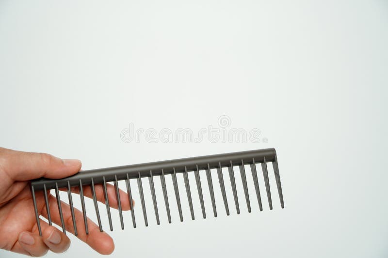 Human Hand Holding a Comb on White Background Isolation Stock Image ...