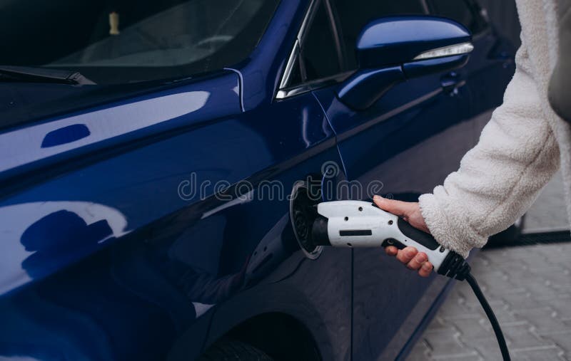 Human Hand is Holding Electric Car Charging Connect To Electric Car ...