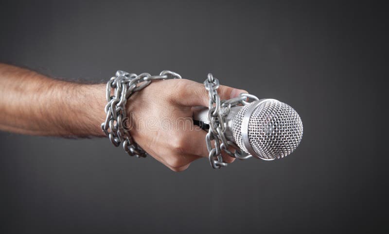 Human Hand Holding Microphone Tied with Chains Stock Image - Image of ...