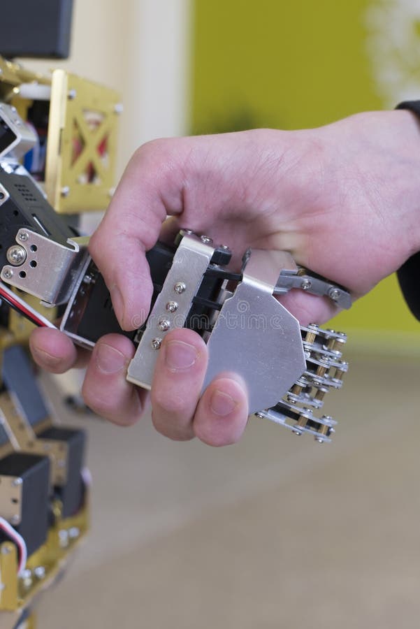 Human Hand Holding a Robot Hand with a Handshake Stock Image - Image of ...