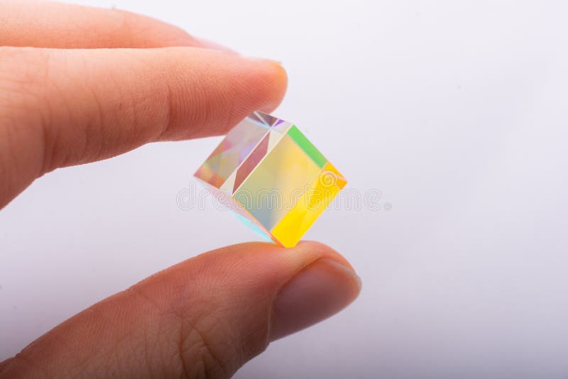 Human Hand Holding a Small Transparent Cube with Yellow and Green ...