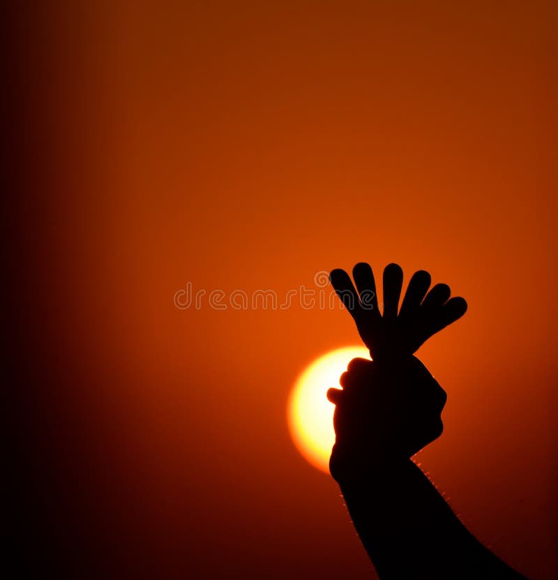 Sunset with Silhouette Object and Hand Background Photograph Stock ...