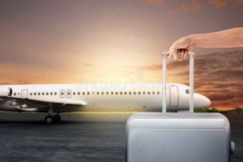 Human Hand Holding a Suitcase for Traveling on the Runway Stock Photo ...