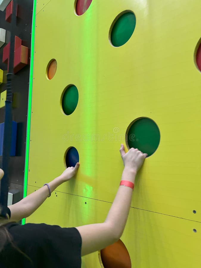 Human Hand Inserted into a Round Hole on a Climbing Wall for Further ...
