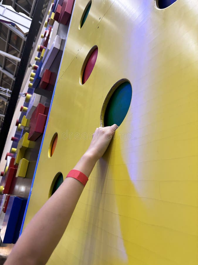 Human Hand Inserted into a Round Hole on a Climbing Wall for Further ...