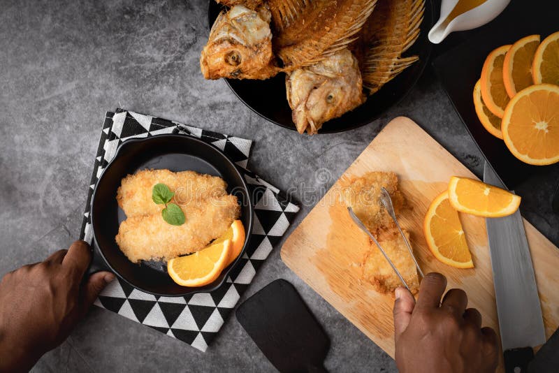 Human Hand Preparing Food, Fried Fish and Sliced Lemon Stock Photo ...