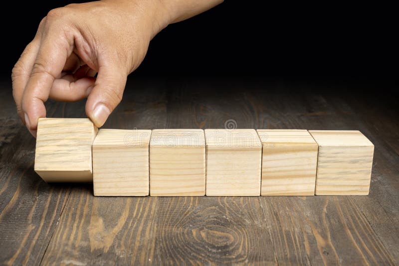 A Human Hand Put a Row of Wooden Cubes Stock Photo - Image of closeup ...