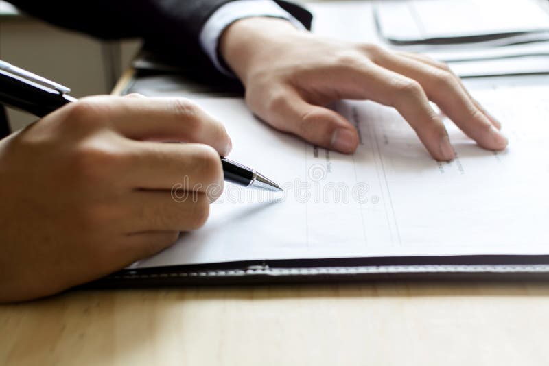Close Up Human Hand Signing On Formal Paper At The Stock Photo - Image ...