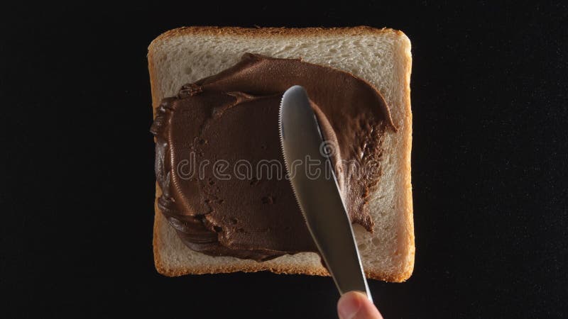 Human Hand Spreads a Chocolate Paste on a Bread Stock Video - Video of ...