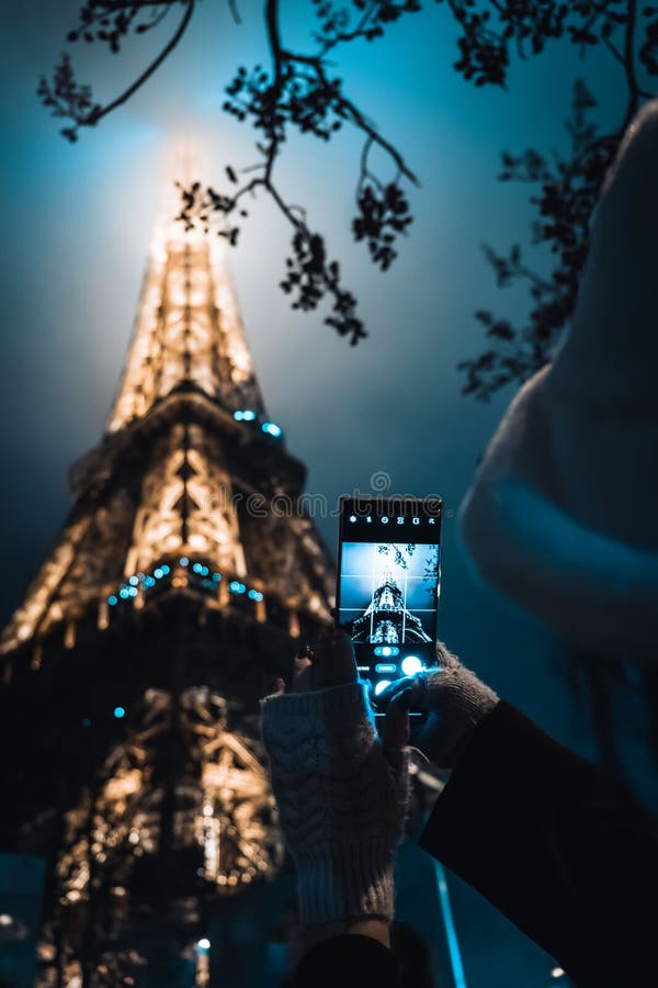 Human Hand Taking a Picture of the Eiffel Tower with a Phone on Dark ...