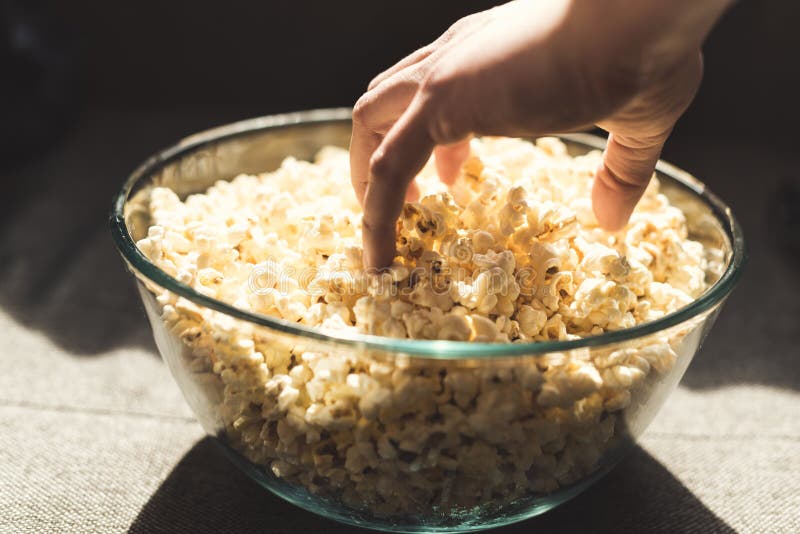 Human hand taking popcorn stock image. Image of hand - 93031945