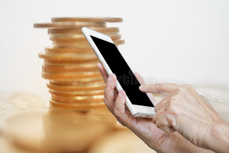 Human Hand Touch Smartphone Screen with Blurred Stack of Coins ...