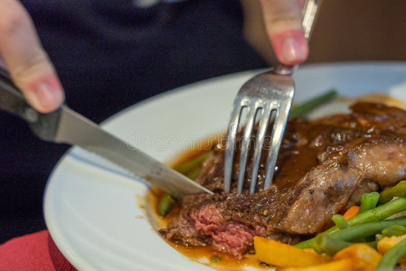 Human Hand Using Spoon and Fork while Having Beef Steak Stock Image ...