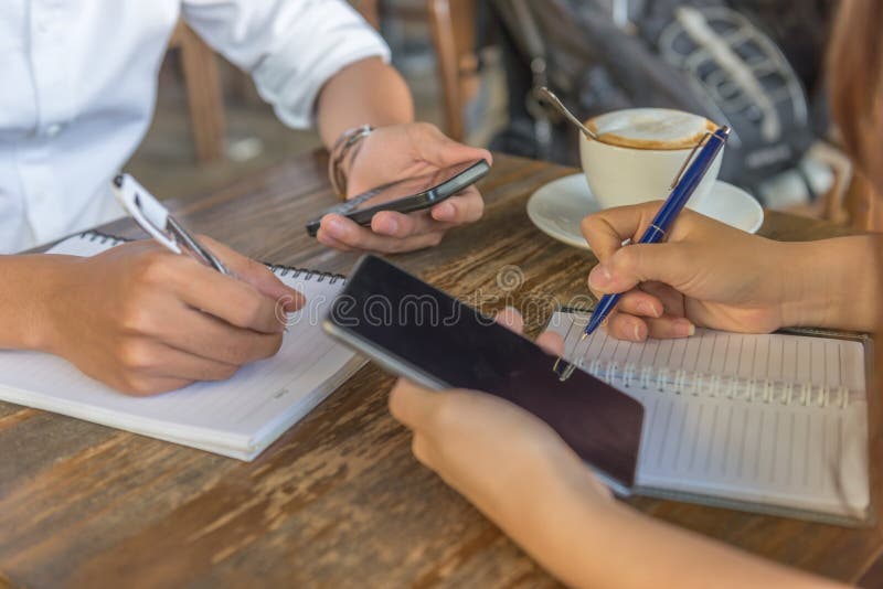 Human Hand Writing into Notes and Using Smartphone Stock Photo - Image ...