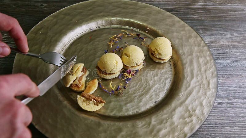 Human Hands Cut Off One of Spherical Sponge Biscuits by Fork and Knife ...