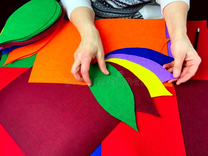 Human Hands that Make Applique Petals of Colored Felt. Stock Image ...