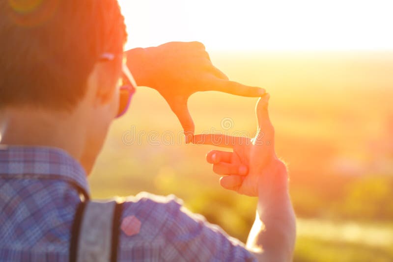 Human Hands Making a Frame Sign Over Sunset Sky Stock Image - Image of ...
