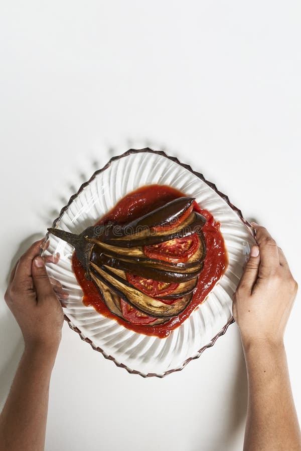 Human Hands Putting Delicious Dish Made of Eggplant with Tomatoes and ...