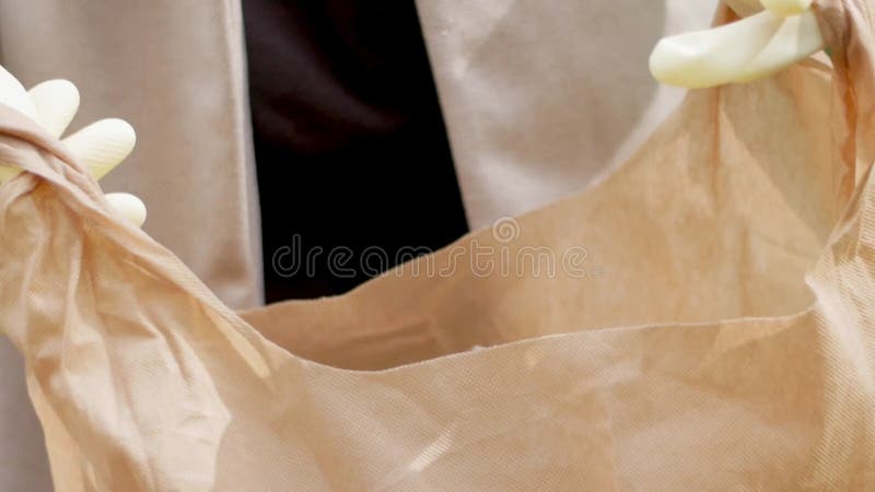 Human Hands in Rubber Gloves with a Garbage Bag Collect Plastic Waste ...