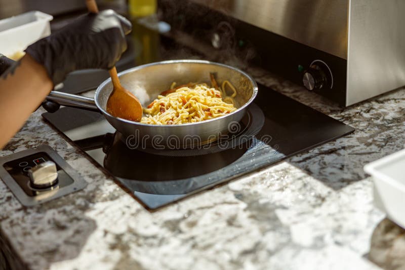 Human Hands Skillfully Cooking Delicious Pasta in a Stylish and Modern ...