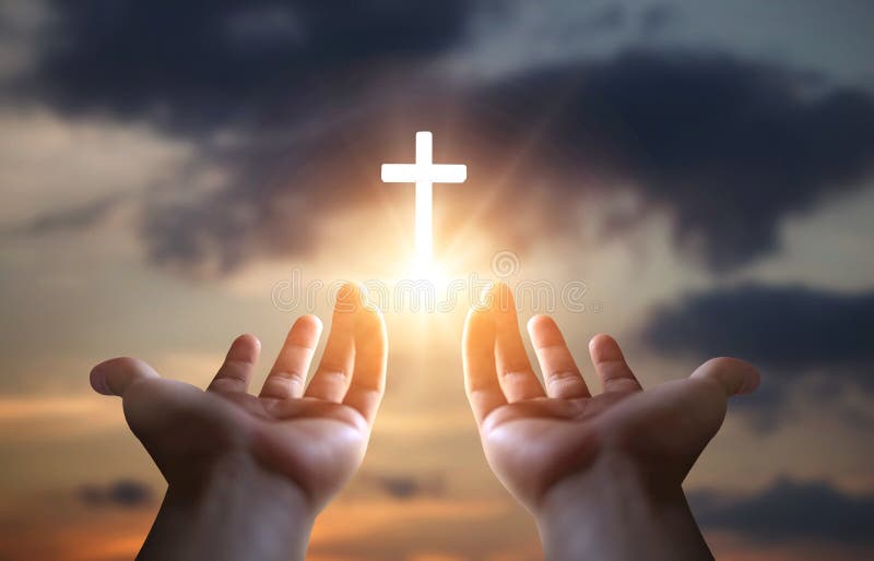 Hands Holding a Cross on Sunset Sky Background. Christian Symbol. Stock ...