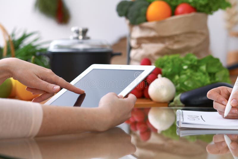 Human Hands of Two Female Persons Using Touchpad for Making Menu in the ...