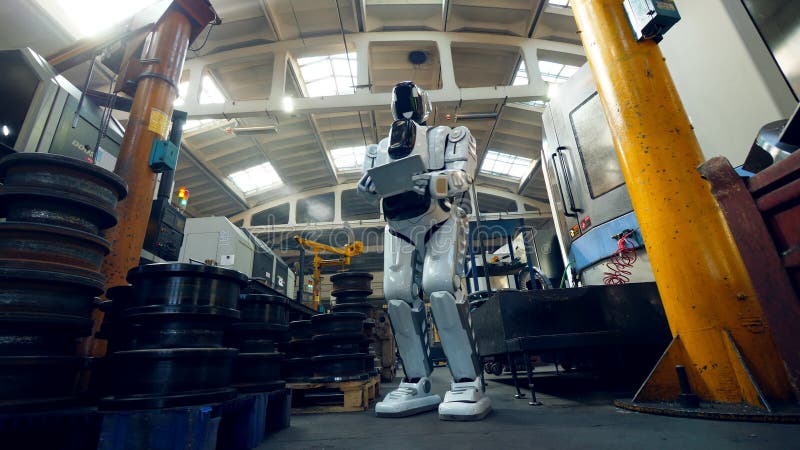 Human Factory Worker and a Robot are Walking Together in Factory ...