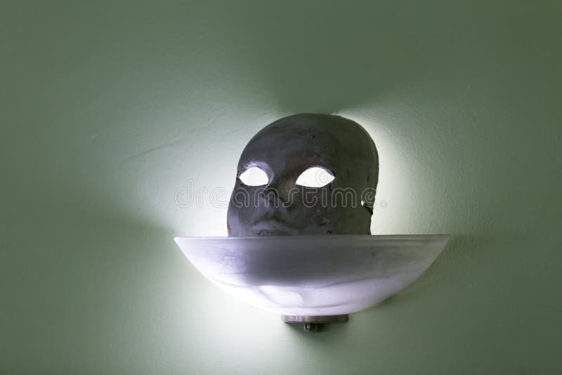 Human Face Mask in Front of an Electric Lamp Stock Image - Image of ...
