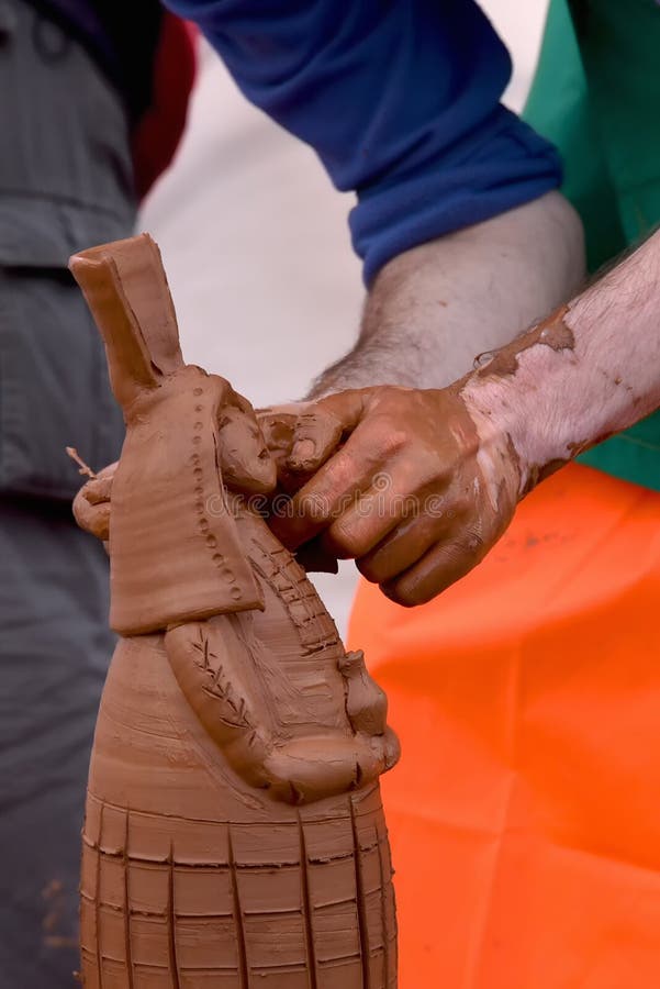 A Human Potter Works with Clay, Making a Ceramic Doll Out of Clay in a ...