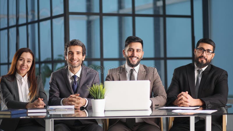 Human Resources Team Sitting in a Row at Table in Office Stock Image ...