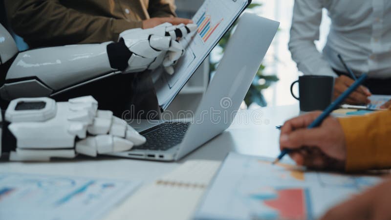 Human and Robot Collaboration in Modern Business Setting with Laptop and Charts for Future ...