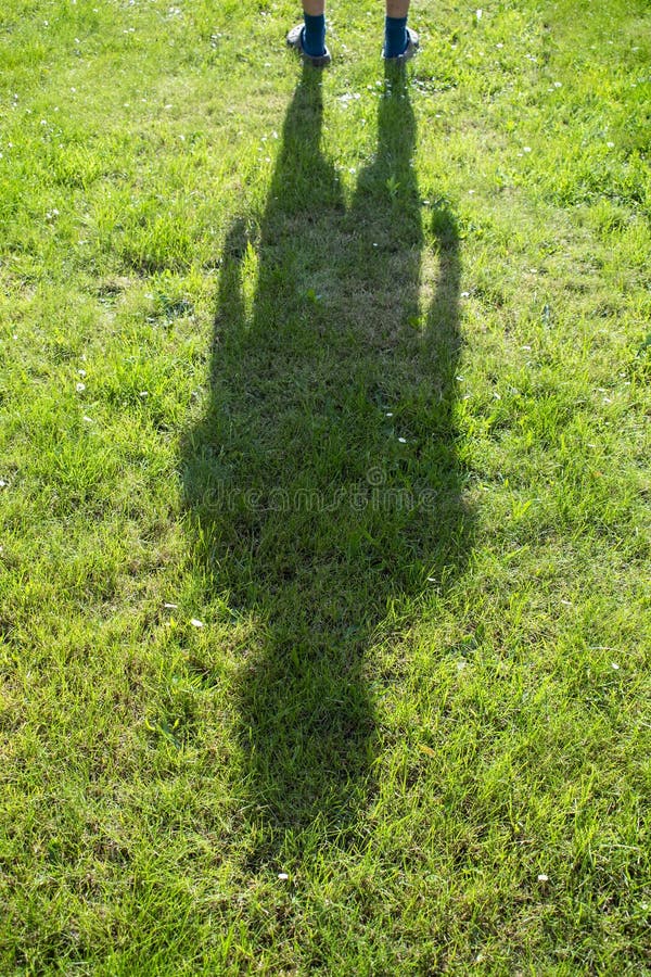 Human Shadow Man / Boy on the Fresh, Bright Grass. Stock Image - Image ...