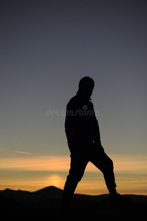 Human silhouette at sunset editorial stock photo. Image of dark - 130439928