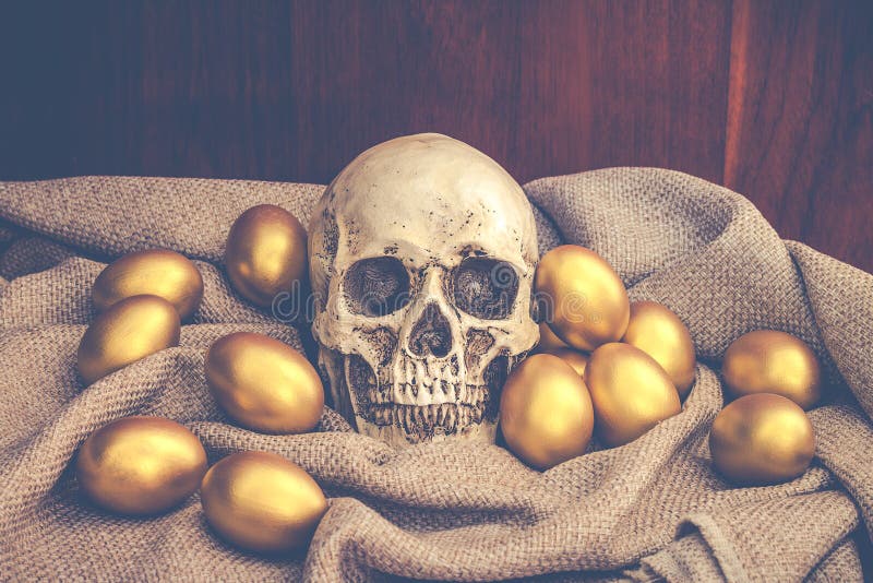 Human Skull Surrounded by Golden Easter Egg on Brown Sack Stock Photo ...