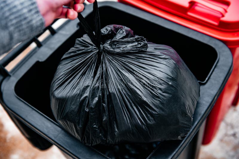 Human Throwing Garbage in Black Trash Cans. Stock Photo - Image of ...