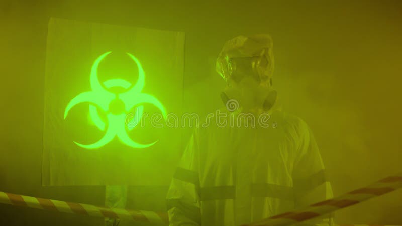Human in Yellow Protective Suit Points. Bacteriological Danger and Haze ...