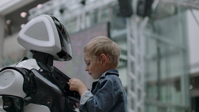 Humanoid Robot Talks with Child at Technology Exhibition. the ...