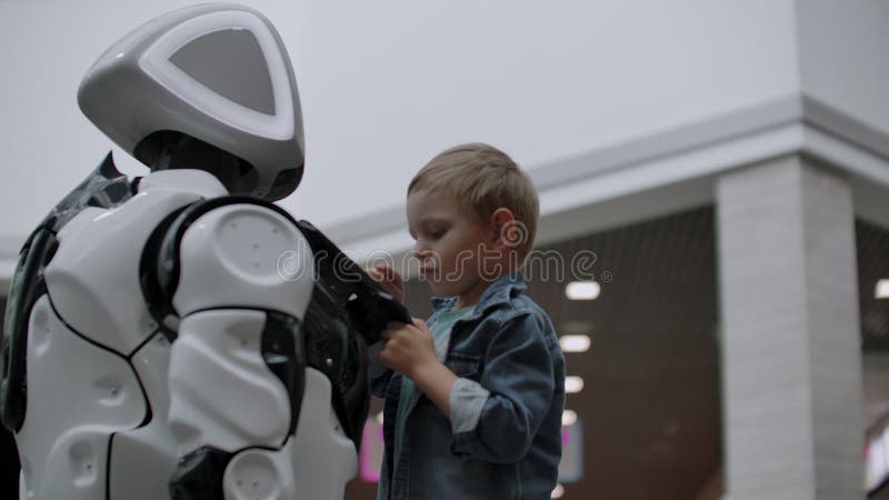 Humanoid Robot Talks with Child at Technology Exhibition. the ...