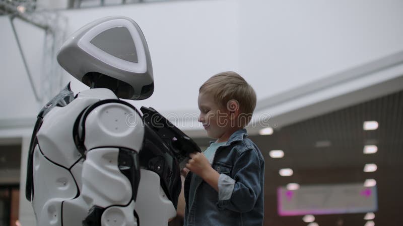 Humanoid Robot Talks with Child at Technology Exhibition. the ...