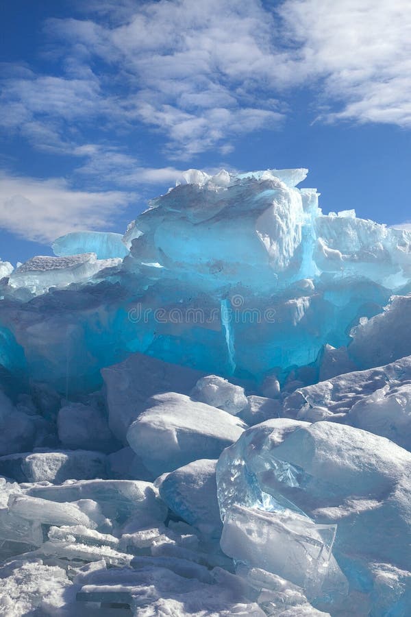 Hummocks of Turquoise Blue Ice Blocks Under White Clouds, Vertical ...