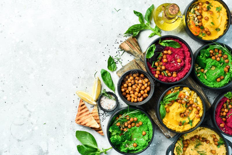Hummus Bowls Background. Traditional Hummus, Herb Hummus, Beetroot ...