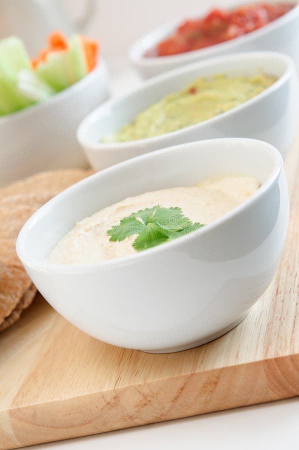 Hummus, Guacamole and Salsa Dip Bowls Stock Image - Image of board ...